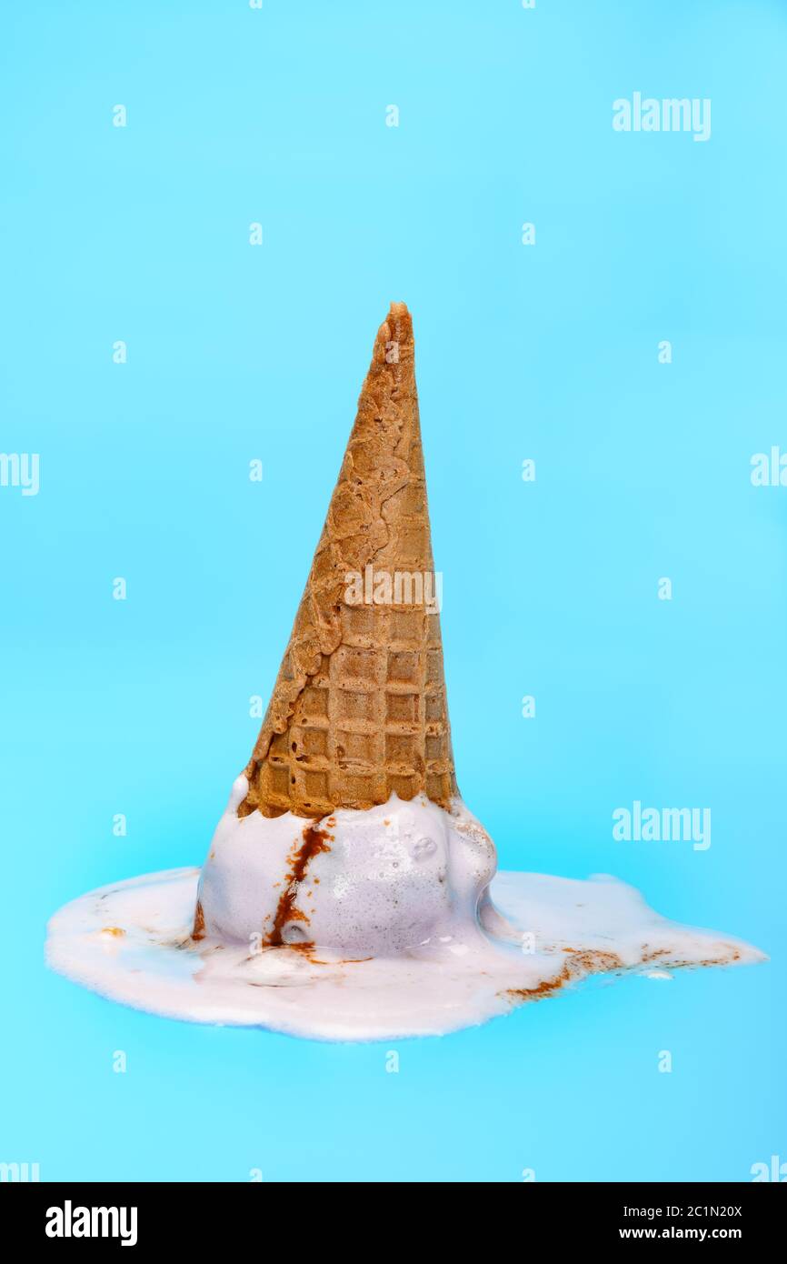Sweet Potato Flavor Ice Cream Cone Upside Down And Melted On Blue