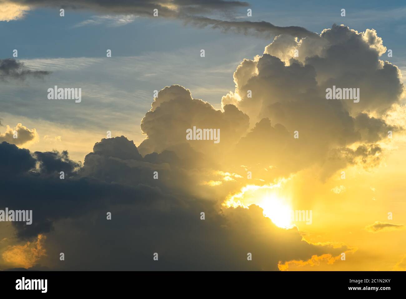 sun behind dark clouds in the sunset time Stock Photo - Alamy