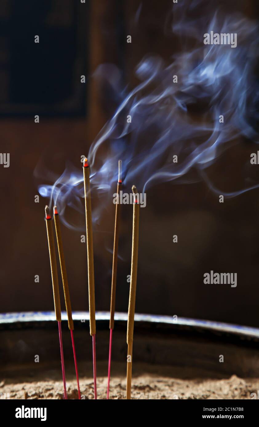 Smoking incense sticks at buddhist temple hi-res stock photography and ...