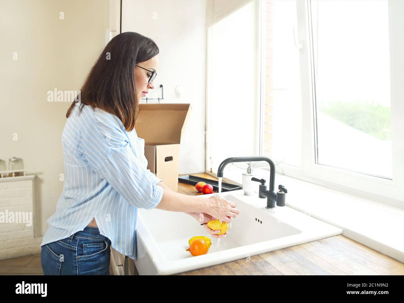 Washing fruits woman hi-res stock photography and images - Alamy