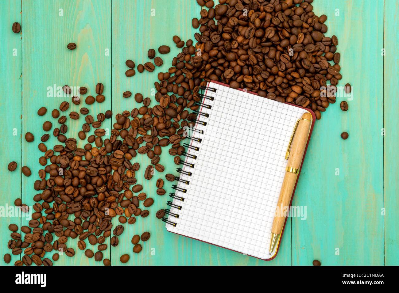 Coffee beans with open notebook for notes Stock Photo - Alamy