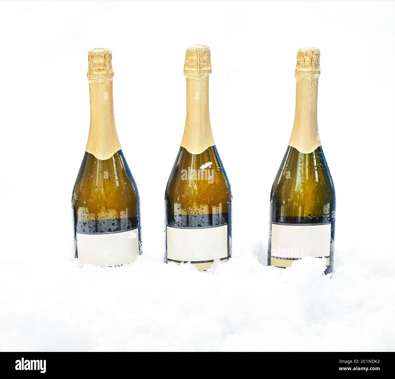 Three bottles of champagne in the snow Stock Photo - Alamy
