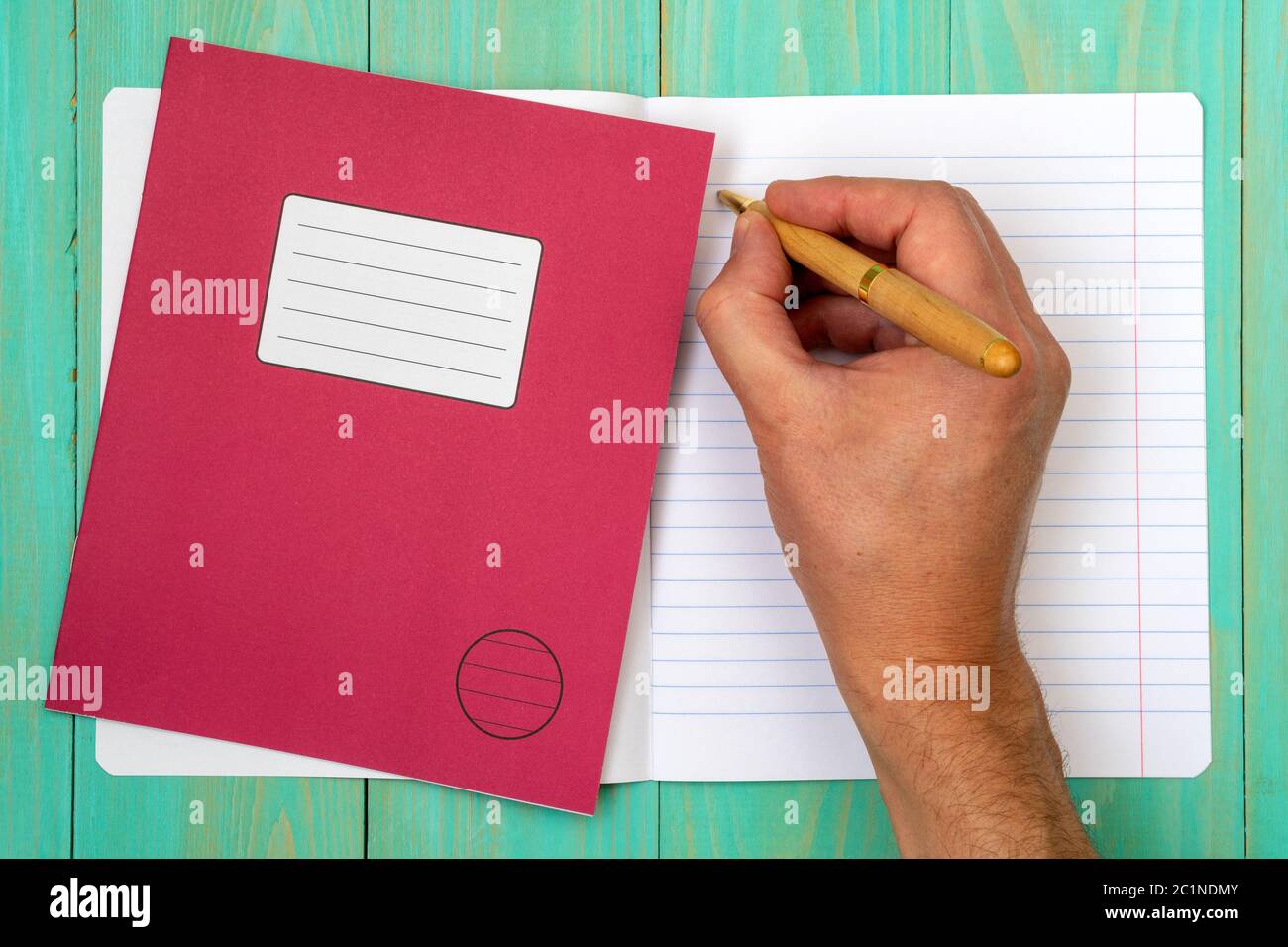 Hand writing in open school notebook Stock Photo - Alamy