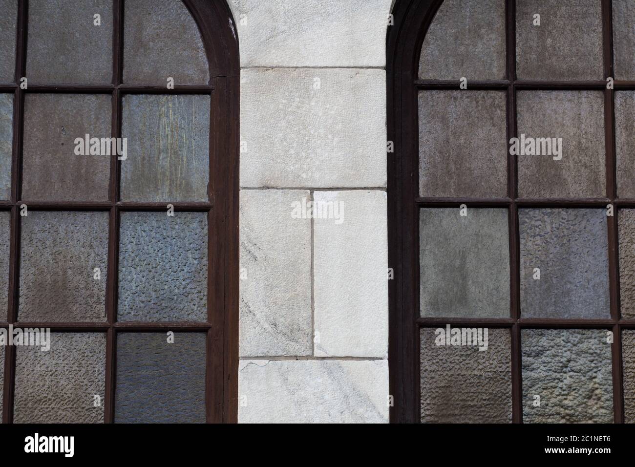 The old and ancient windows in stone wall of a castle, historical close ...