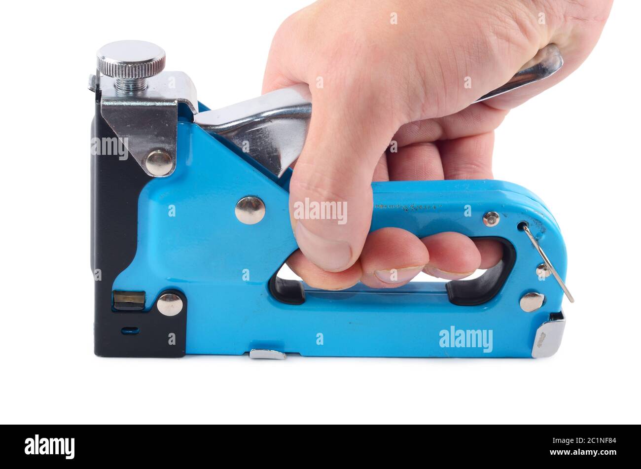 The furniture stapler in a man's hand isolated Stock Photo - Alamy