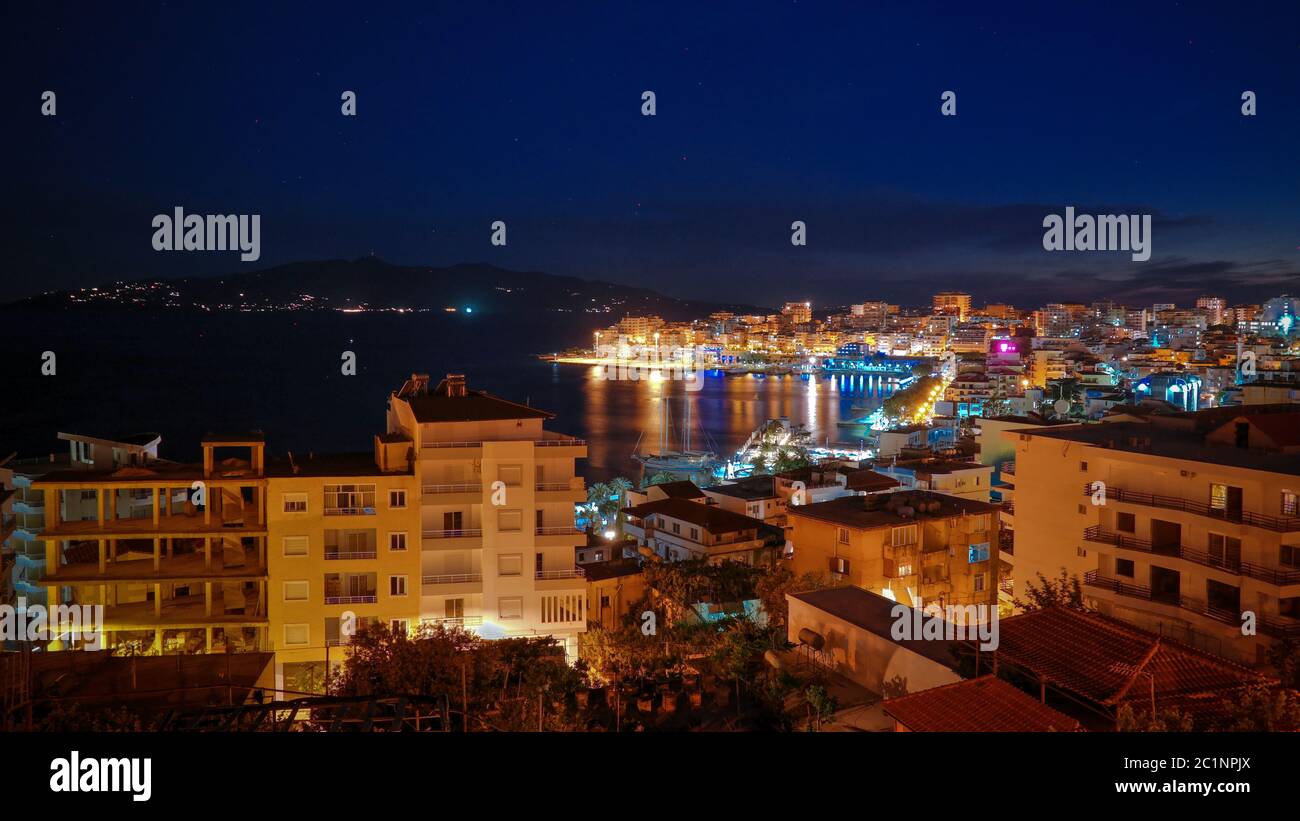 night Aerial Panoramic view to Saranda city and bay of Ionian sea ...