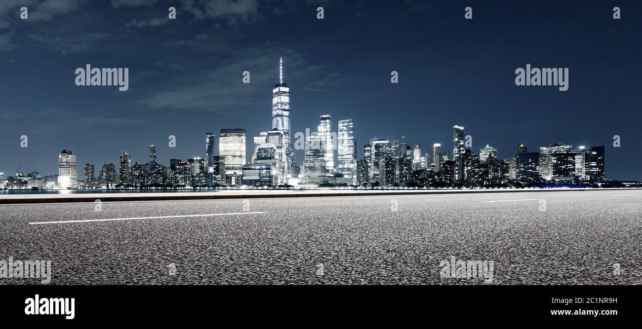 empty asphalt highway with modern cityscape new york at night Stock ...