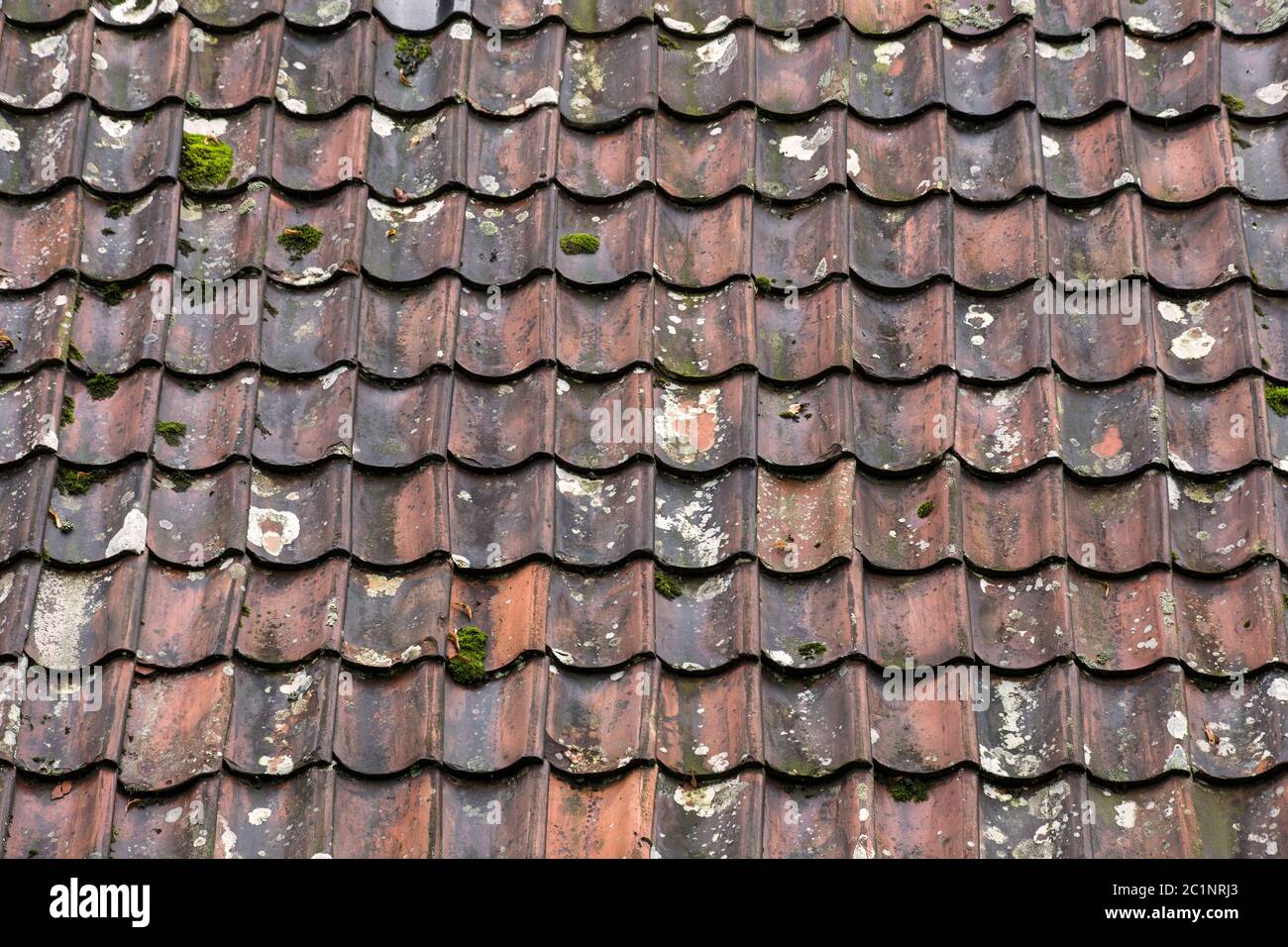 Old and ruined roof tiles close-up. Texture of a roof with old roof ...