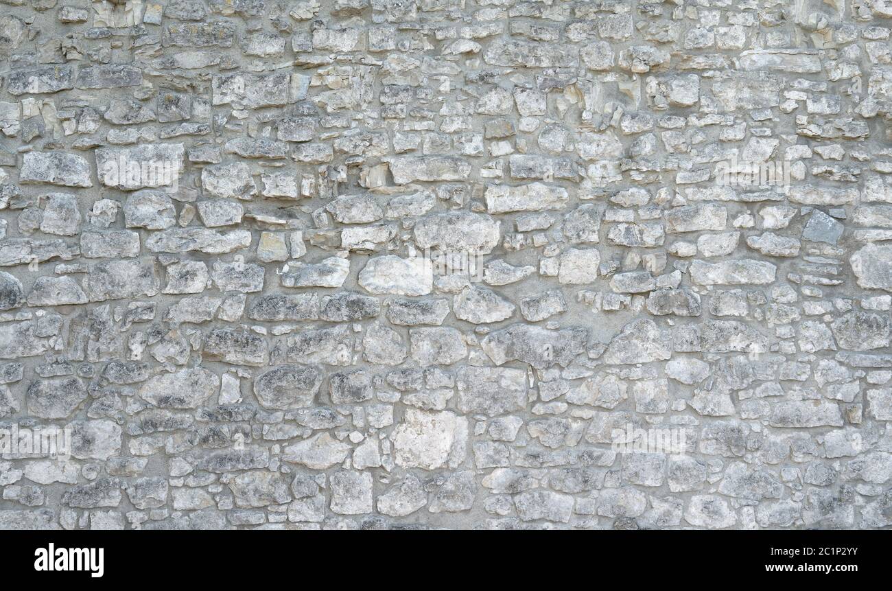 Very old stone wall made of many gray coarse natural stones Stock Photo ...