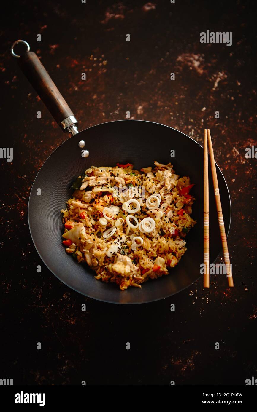 Delicious fried rice with chicken in wok Stock Photo - Alamy