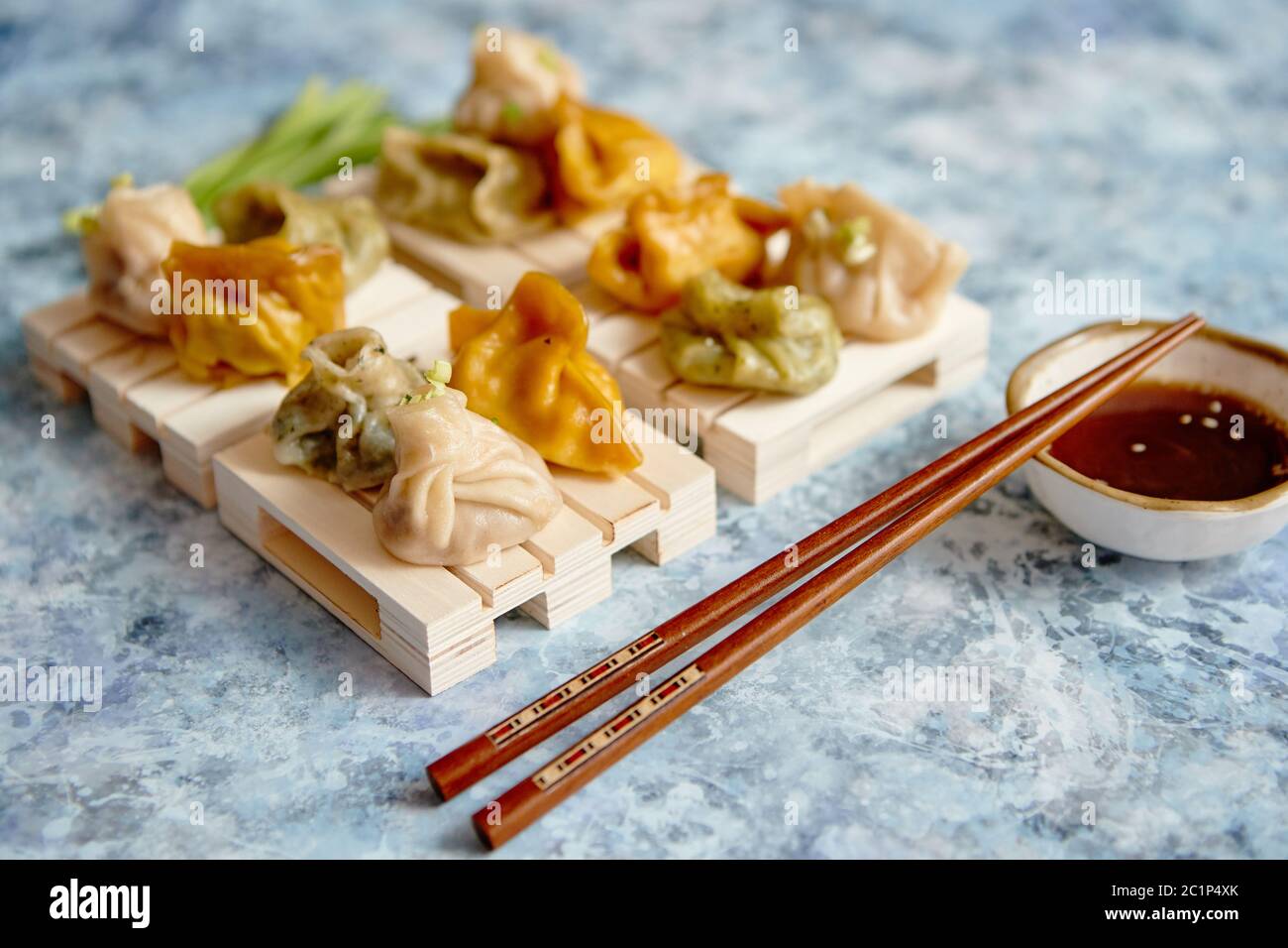 Delicious mixed kinds of chinese dumplings served on wooden stands ...