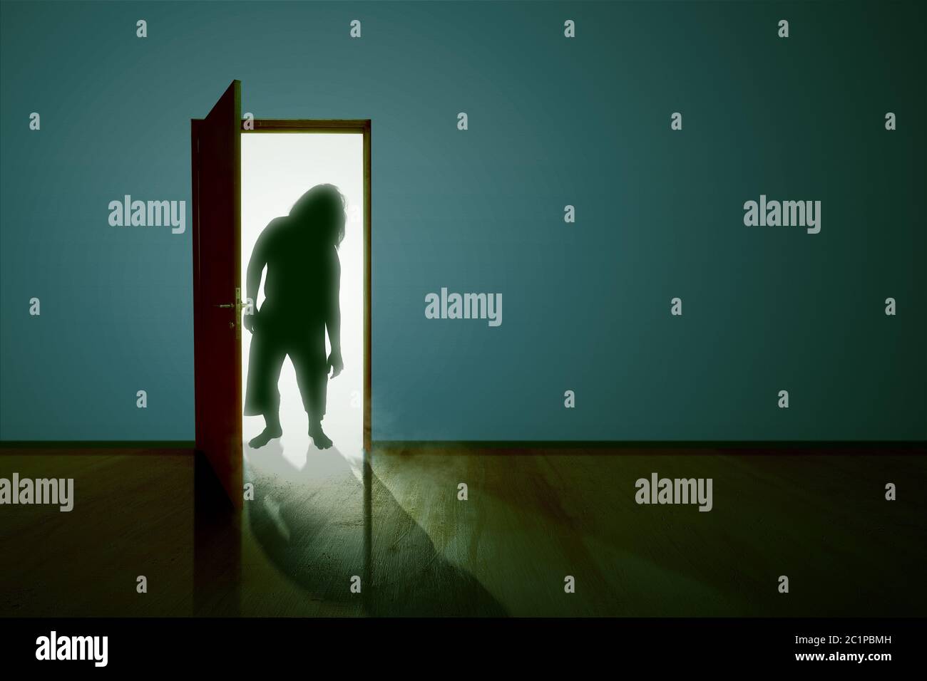 Silhouette of zombie standing on the opened door in the dark room Stock ...