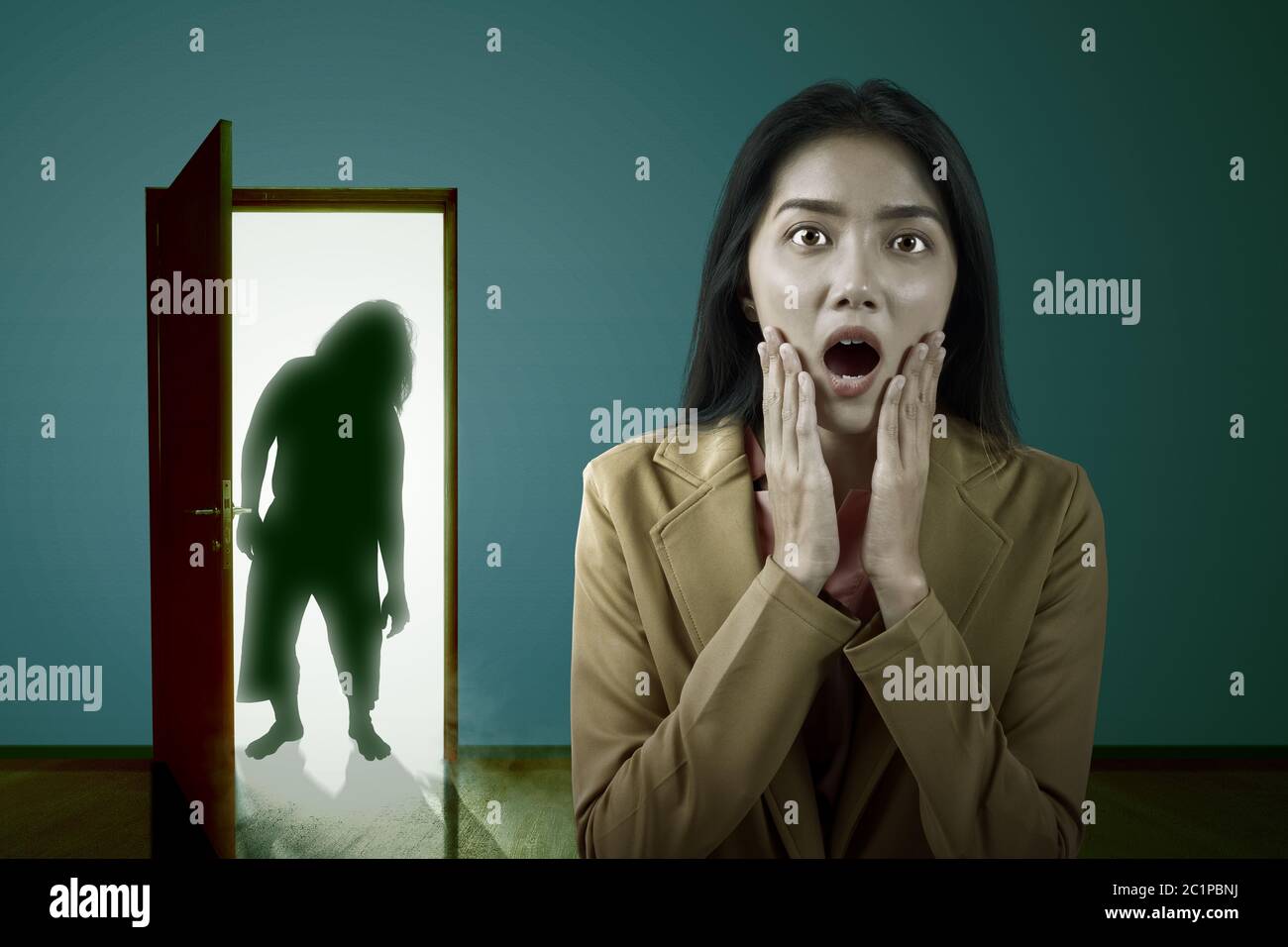 Asian businesswoman scared looking at incoming zombies on the door ...