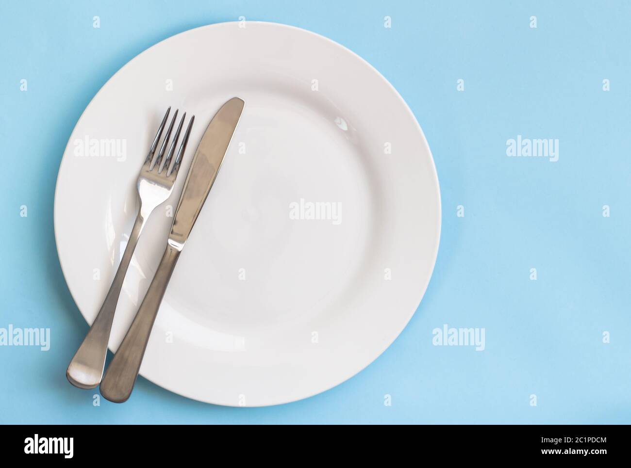 Plate fork knife blue background hi-res stock photography and images ...