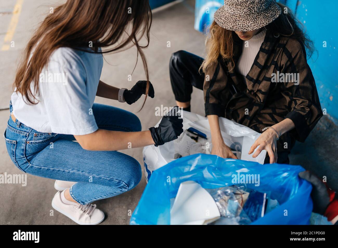 Two young women sorting garbage. Concept of recycling. Zero waste Stock ...