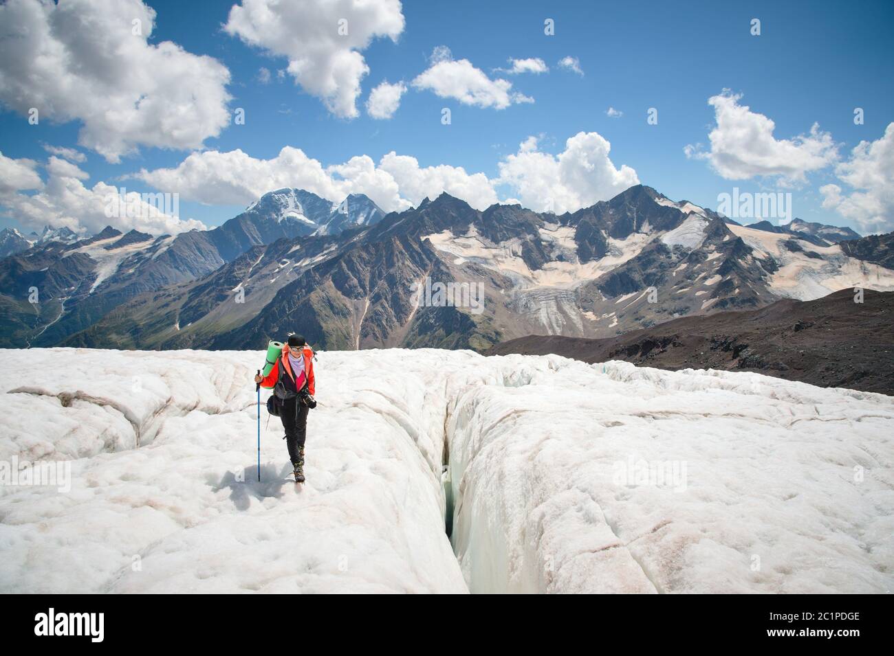 Female mountaineer enjoying the beauty of the glacier walks on the ...