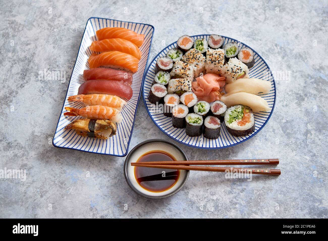 Asian food assortment. Various sushi rolls placed on ceramic plates ...