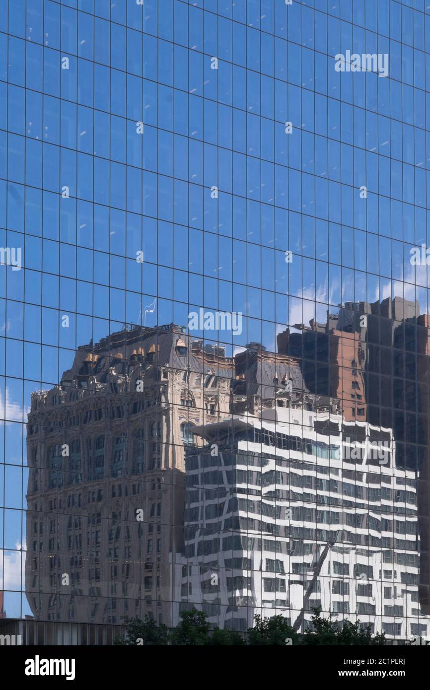 Buildings and sky reflected in the glass windows of a skyscraper in New ...