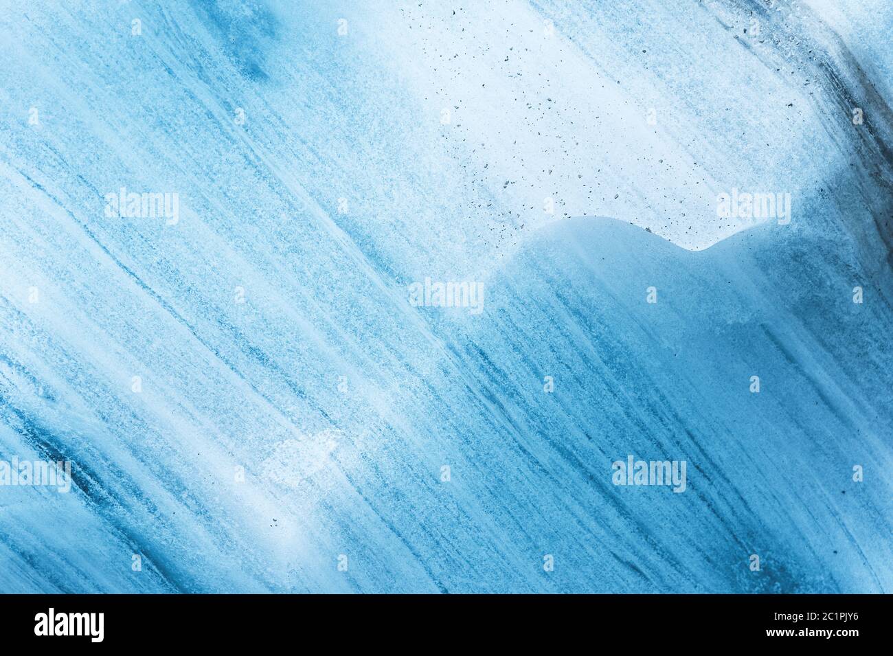 Close-up wall of a centuries-old glacier with a structure of stripes ...