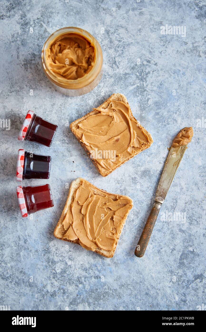 Two tasty peanut butter toasts placed on stone table Stock Photo - Alamy