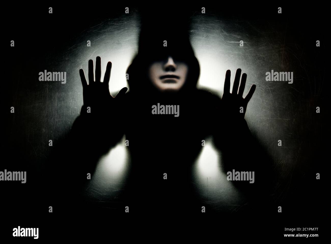 Ghostly figure behind a dusty scratched glass. Mystery man with mask ...