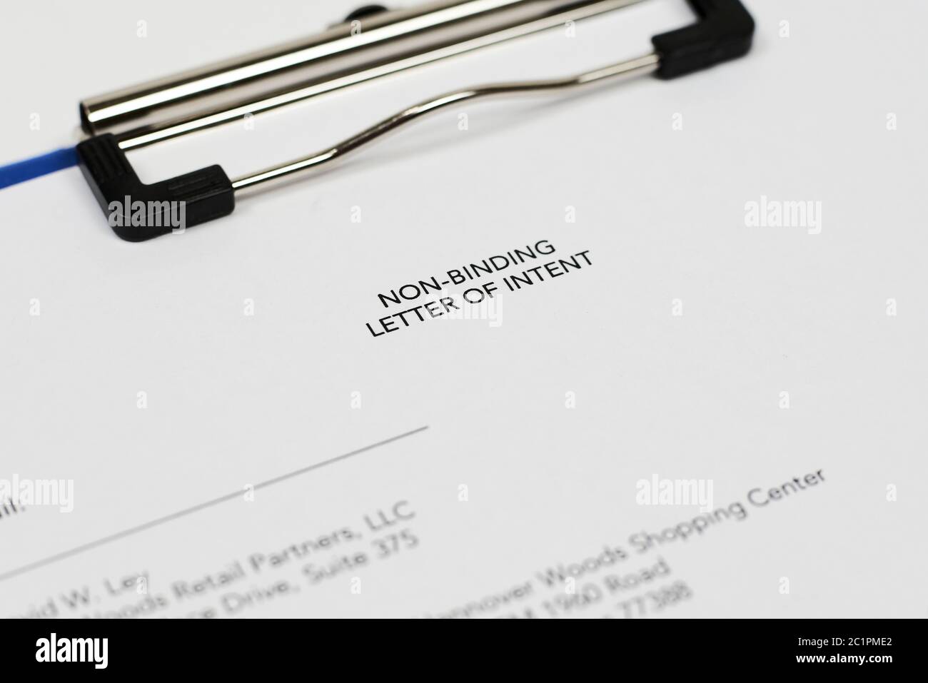 An unrecognizable person filling non-binding letter of intent. Close-up ...