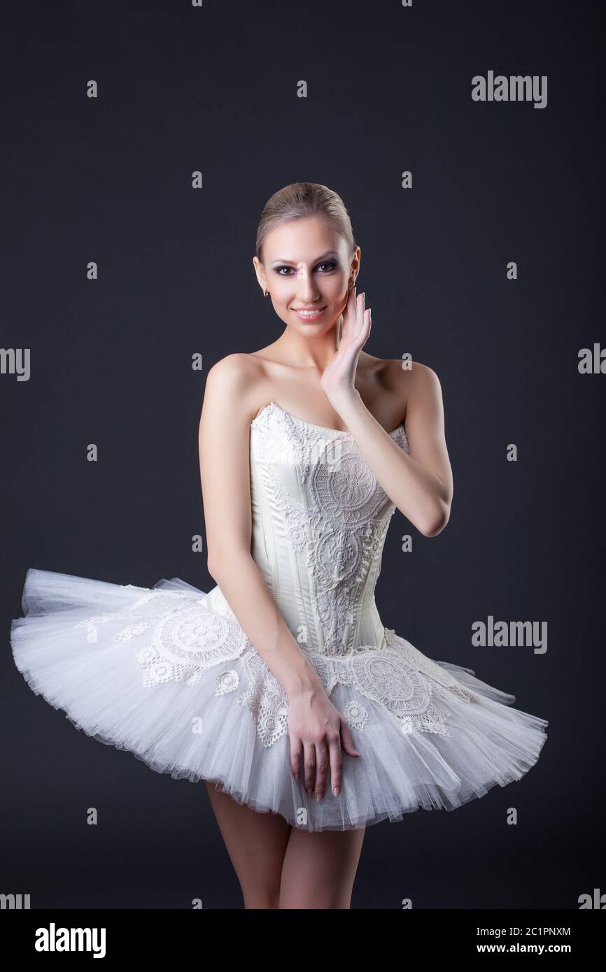 Young charming ballerina posing smiling at camera Stock Photo - Alamy