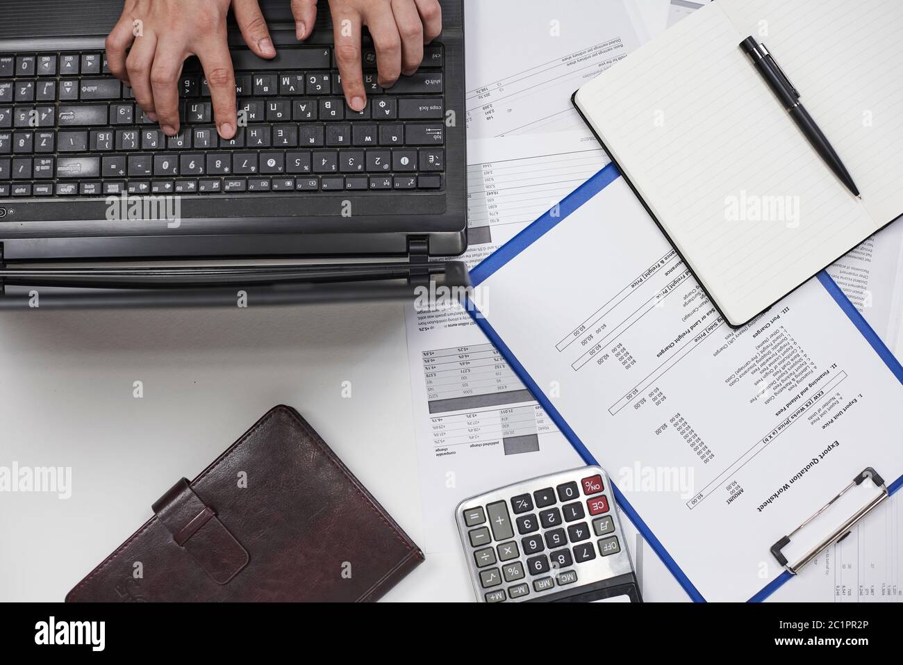 Calculating export import cost. Stack of statistic data, calculator and ...