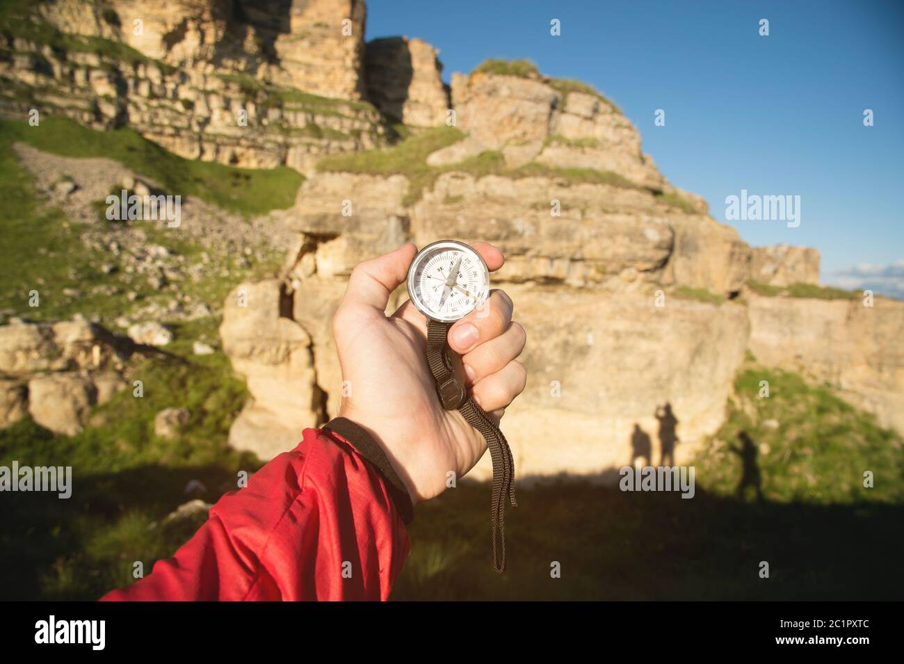 first-person view seeks direction with a compass in hand in the summer ...