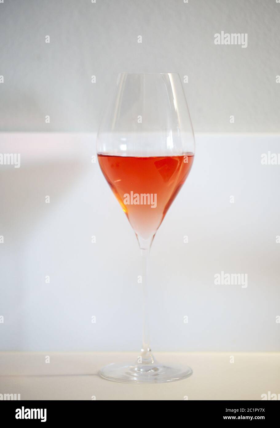Glass of rose wine on white background Stock Photo - Alamy