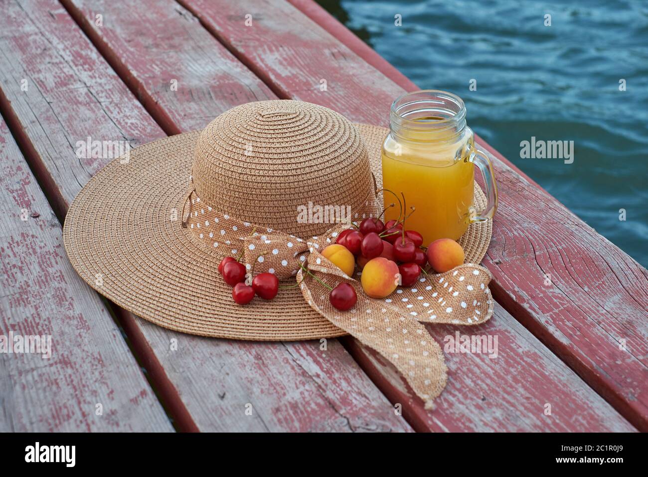Glass of tropical exotic multifruit juice and fruits at the pier ...
