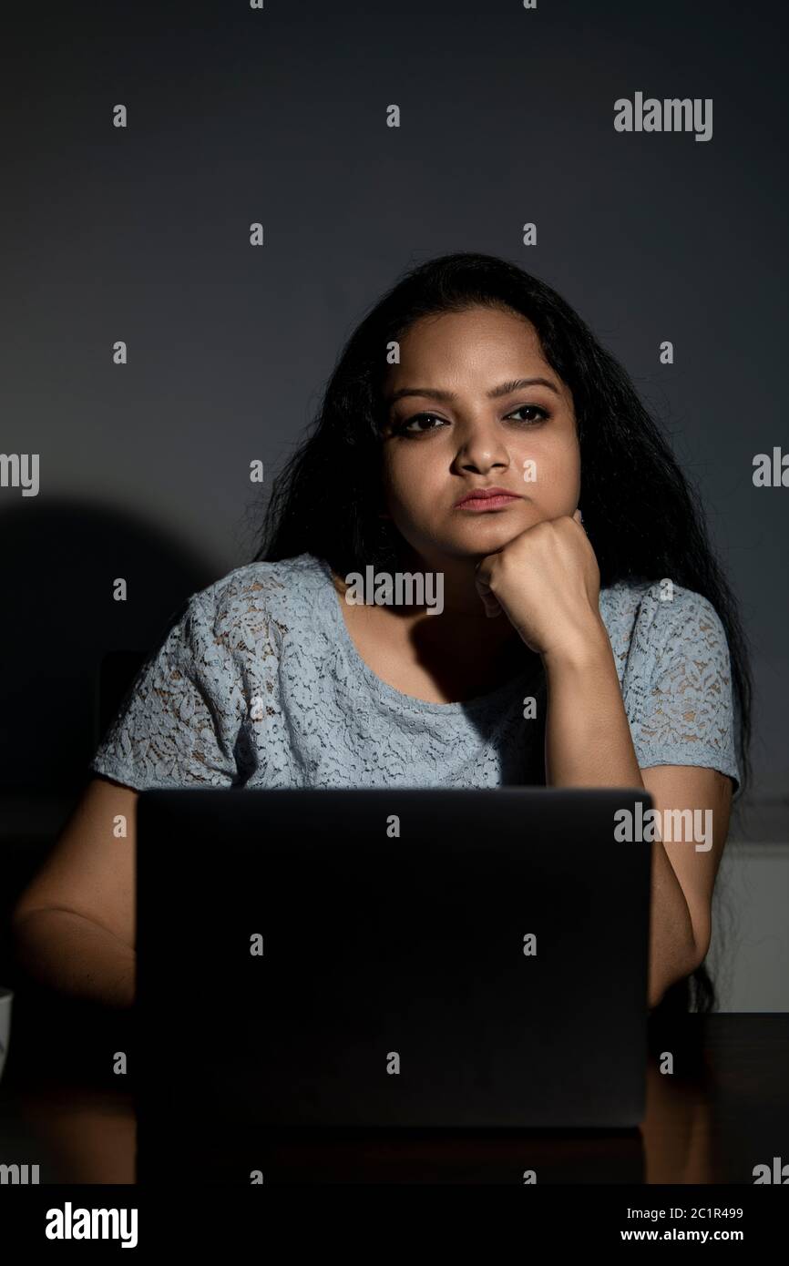 An Indian lady working late at night on her computer Stock Photo - Alamy