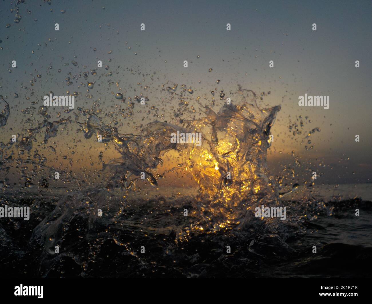 Silhouette of water splash at sunset, next to the sea Stock Photo - Alamy