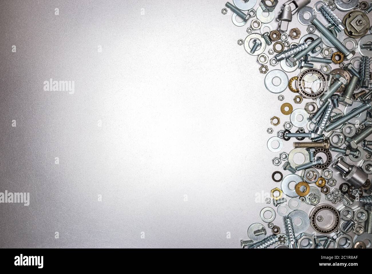 different sizes of screws, bolts and nuts for home repair work on metallic grey background Stock ...