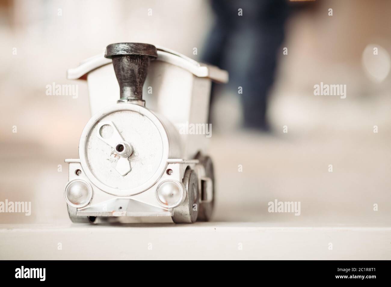 Toy metallic train with clock on the front Stock Photo - Alamy