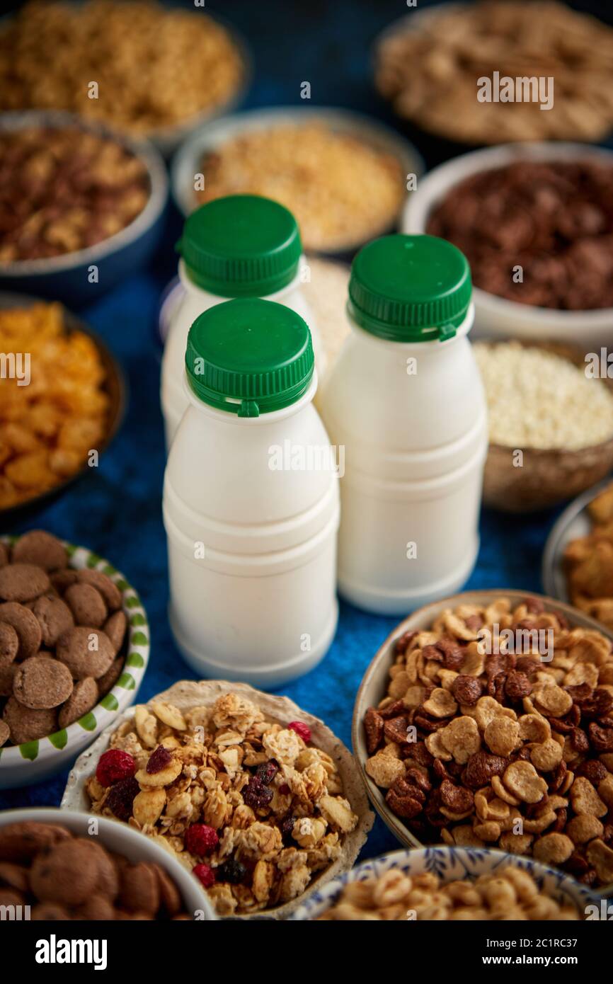 Assortment of different kinds cereals placed in ceramic bowls on table ...