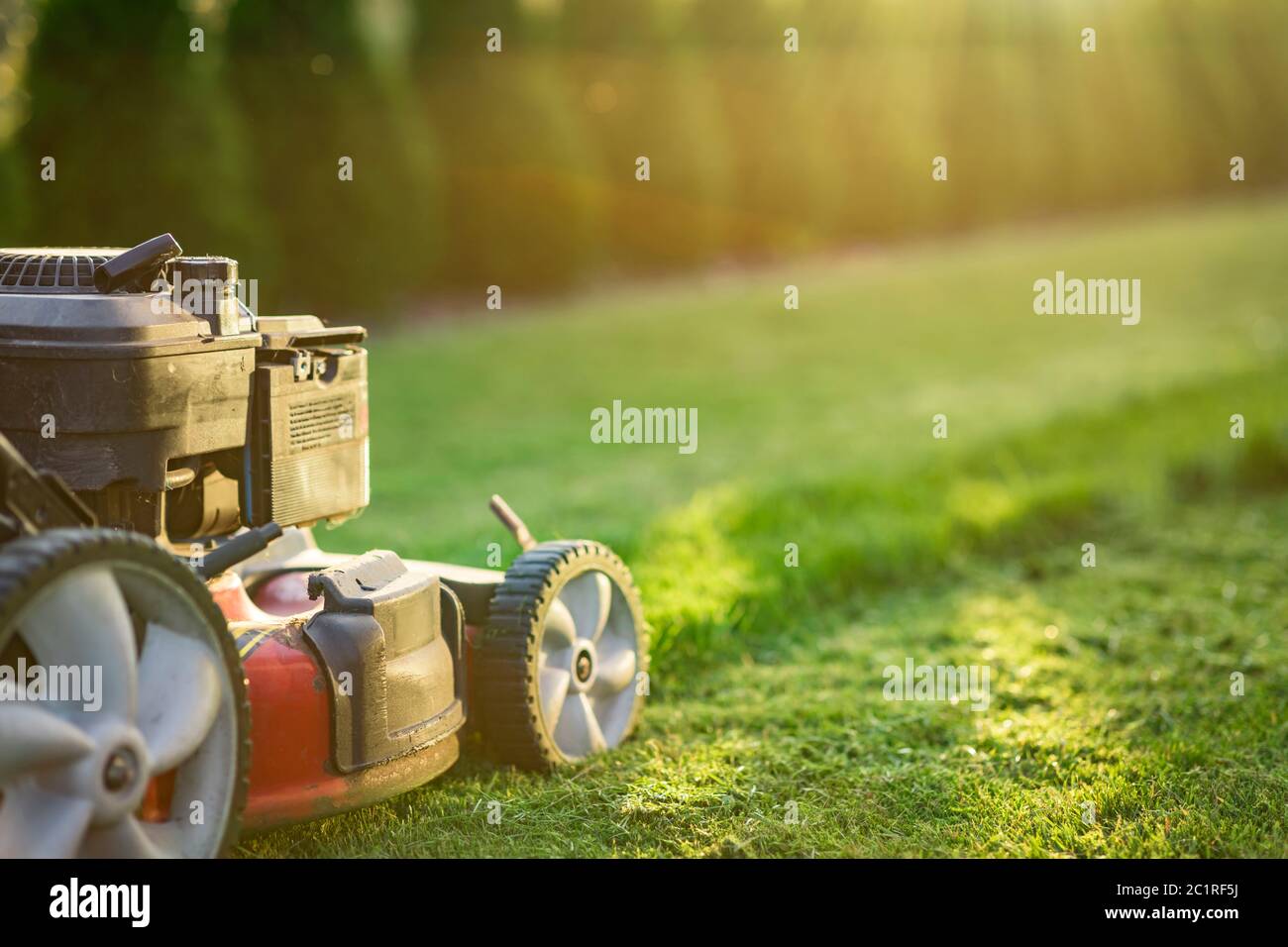 Lawn mower cutting green grass Stock Photo - Alamy