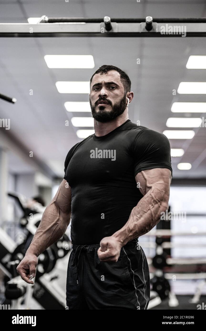 young bearded athlete with strong muscle in gym during posing Stock ...
