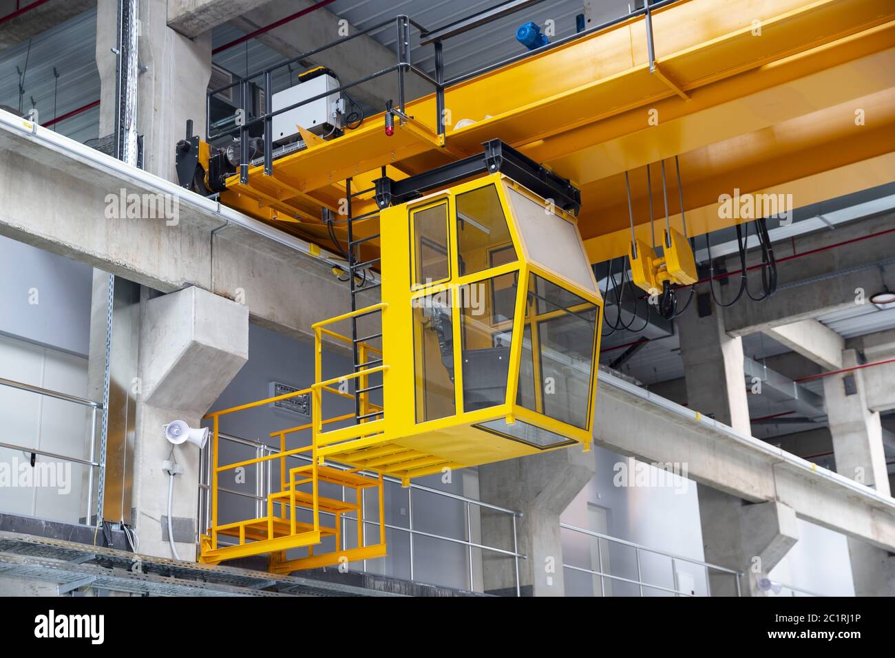 Indoors overhead crane with a cabin Stock Photo - Alamy