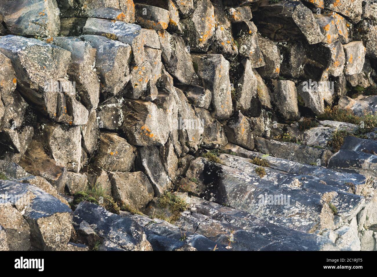 Textured basalt background hexagonal stone pillars in a section ...