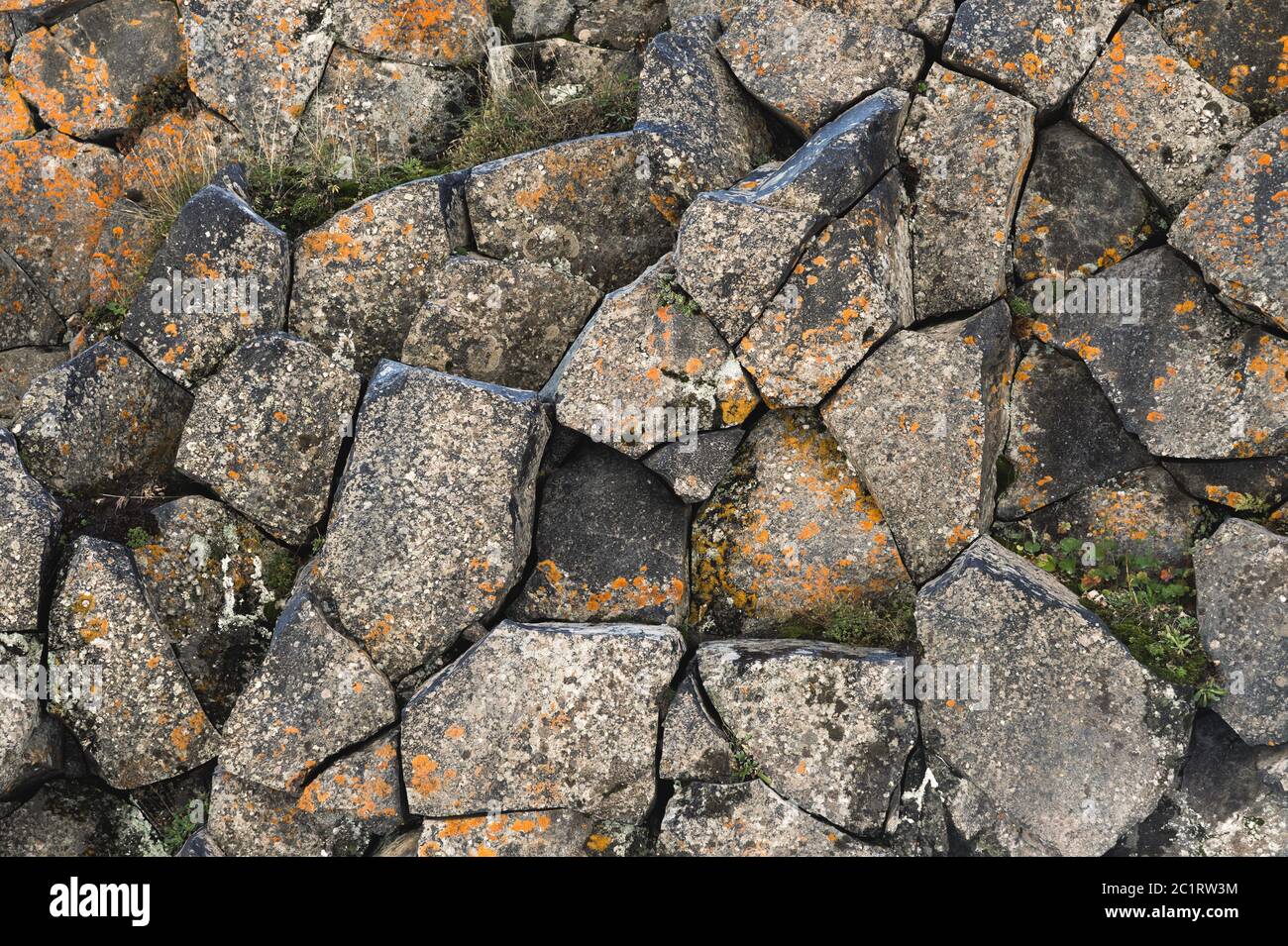 Textured basalt background hexagonal stone pillars in a section ...
