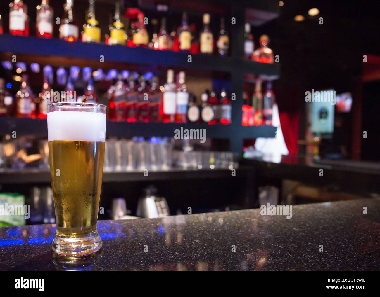 Foaming cold beer on bar at pub Stock Photo - Alamy