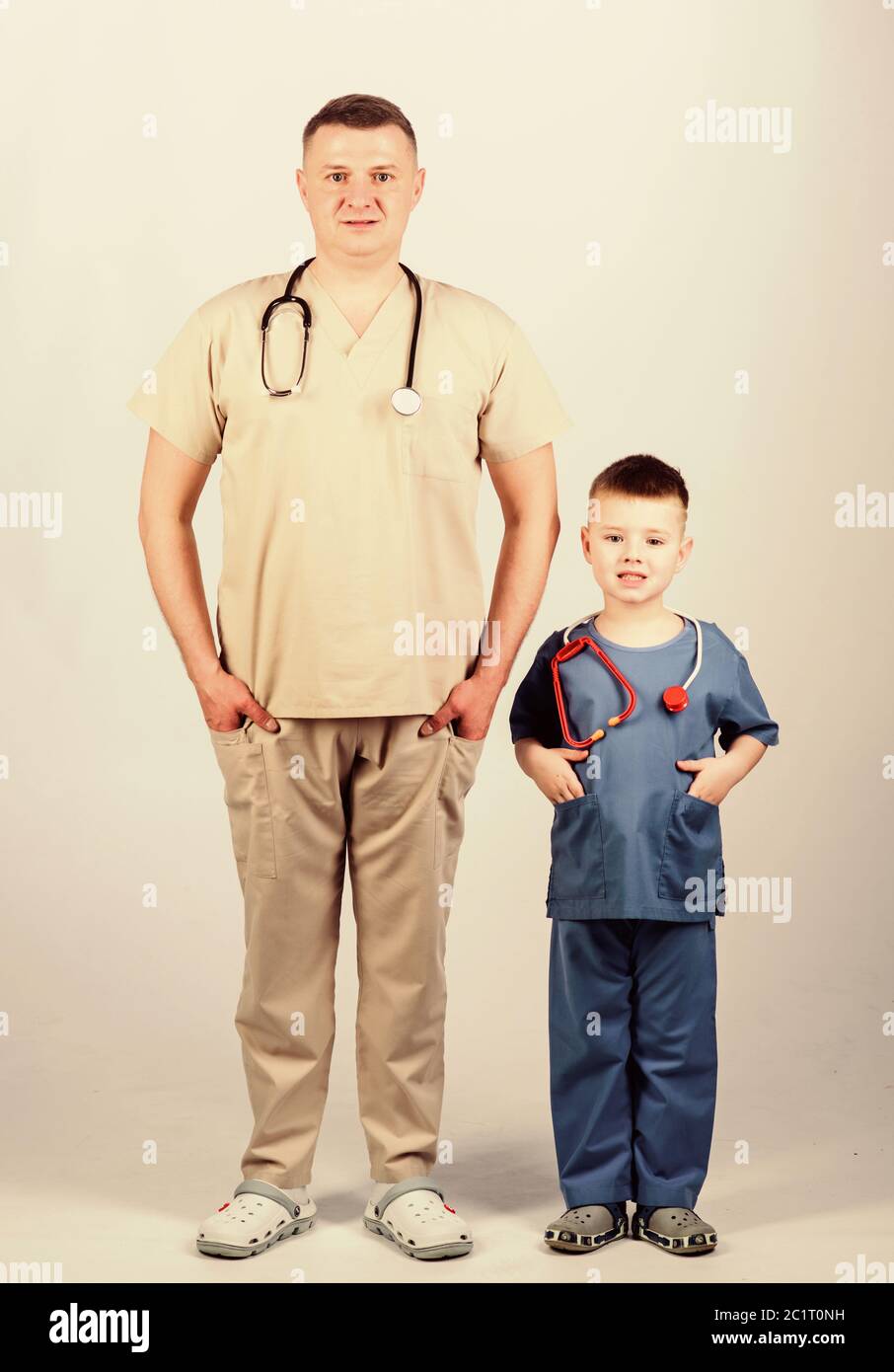 Future profession. Want to be doctor as dad. Cute kid play doctor game ...