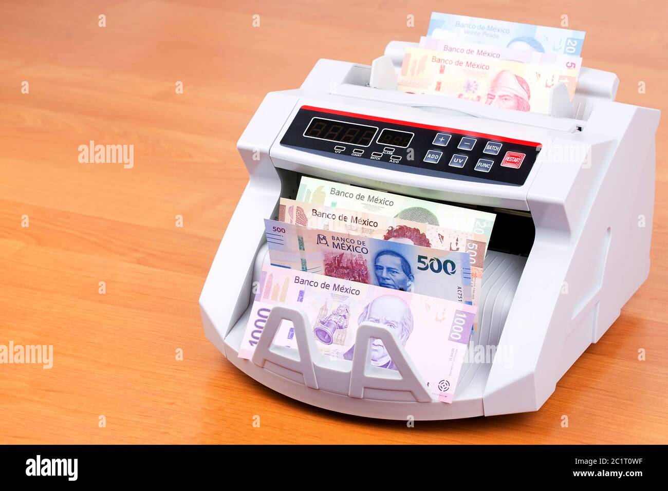 Mexican Peso in a counting machine Stock Photo - Alamy