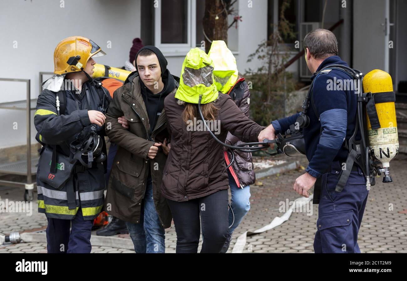 Firefighters take out people with gas masks Stock Photo - Alamy