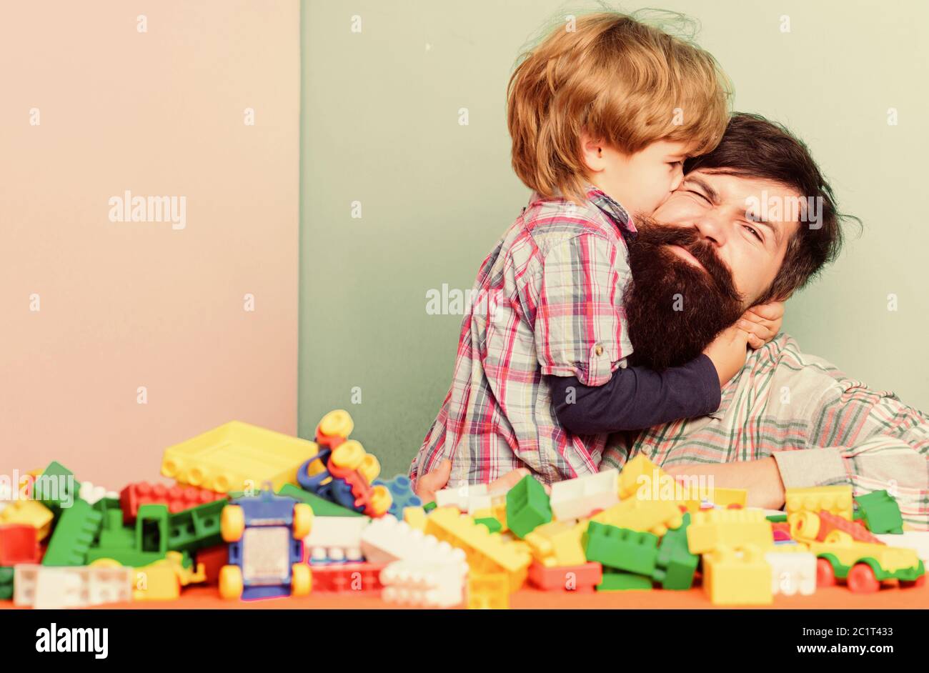 Father and son have fun with bricks. Child development and upbringing. Bearded hipster and boy ...