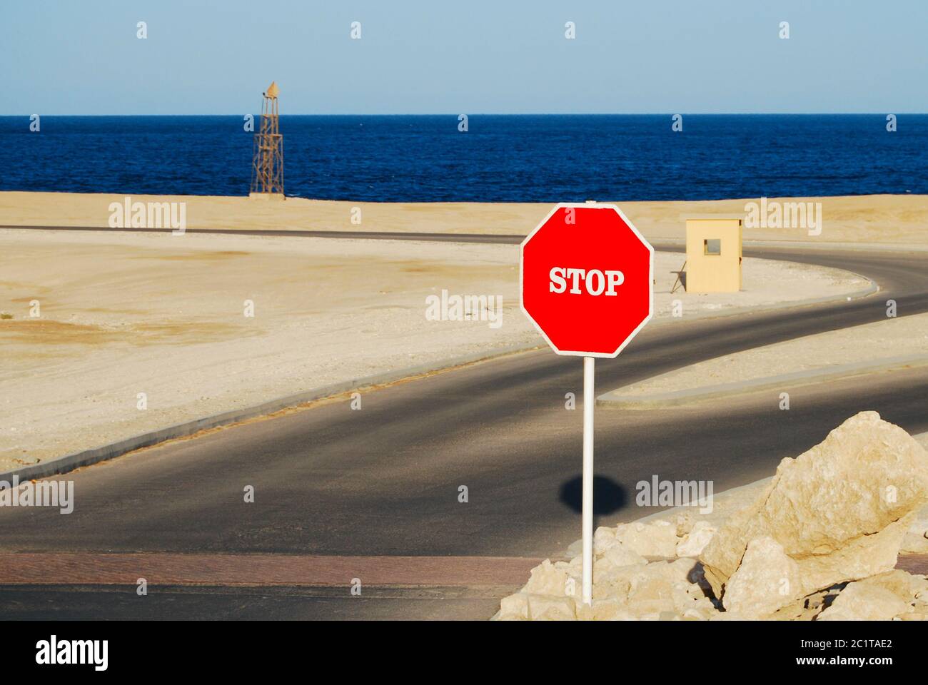 Sand beach coast with red Stop sign Stock Photo - Alamy