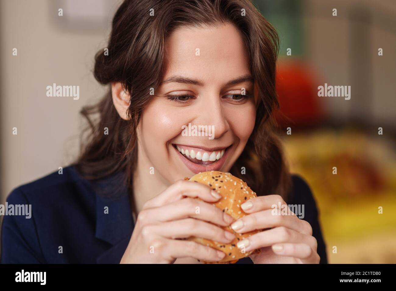 Woman eating burger office hi-res stock photography and images - Alamy