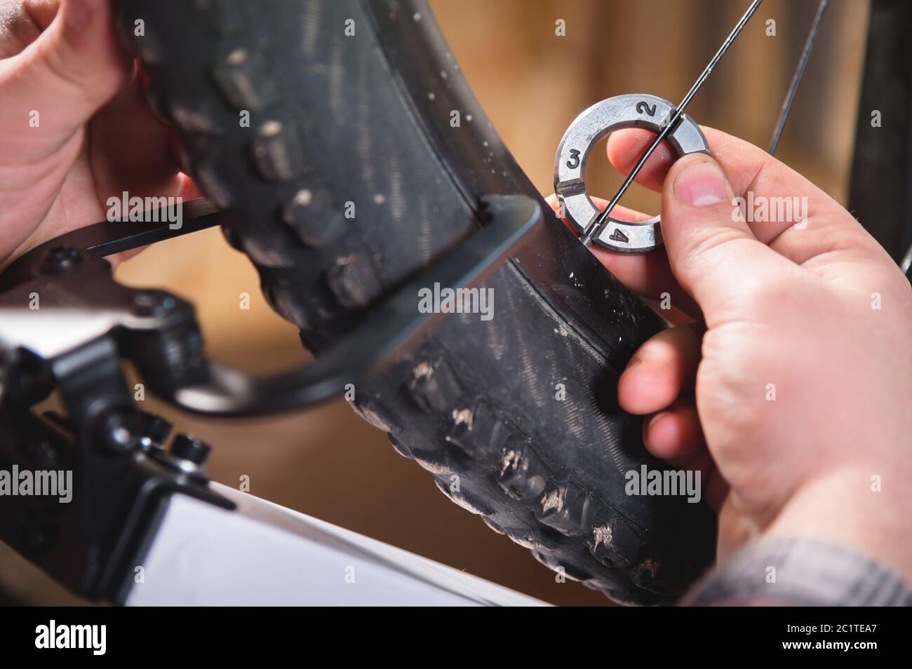 Close-up of men's hands with a specialized wrench on a stand in the ...