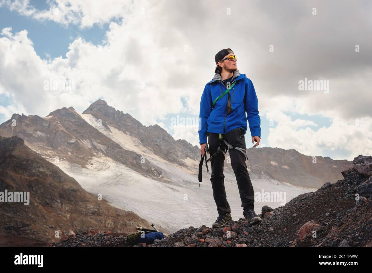 Portrait of a professional guide of a mountaineer in a cap and ...